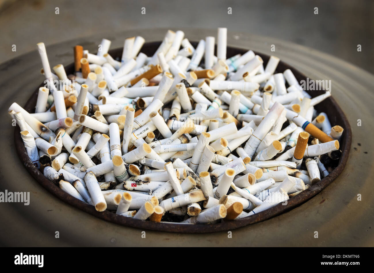 large ashtray full of many cigarette butts Stock Photo - Alamy
