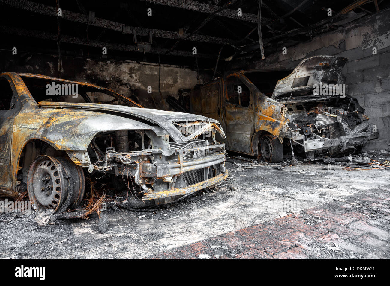 Close up photo of a burned out cars in garage after fire for grunge use ...