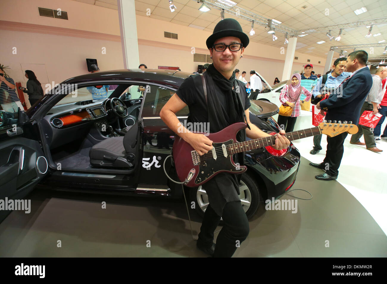 Guitalist demonstrating the sound system of VW Beetle Fender edition at ...