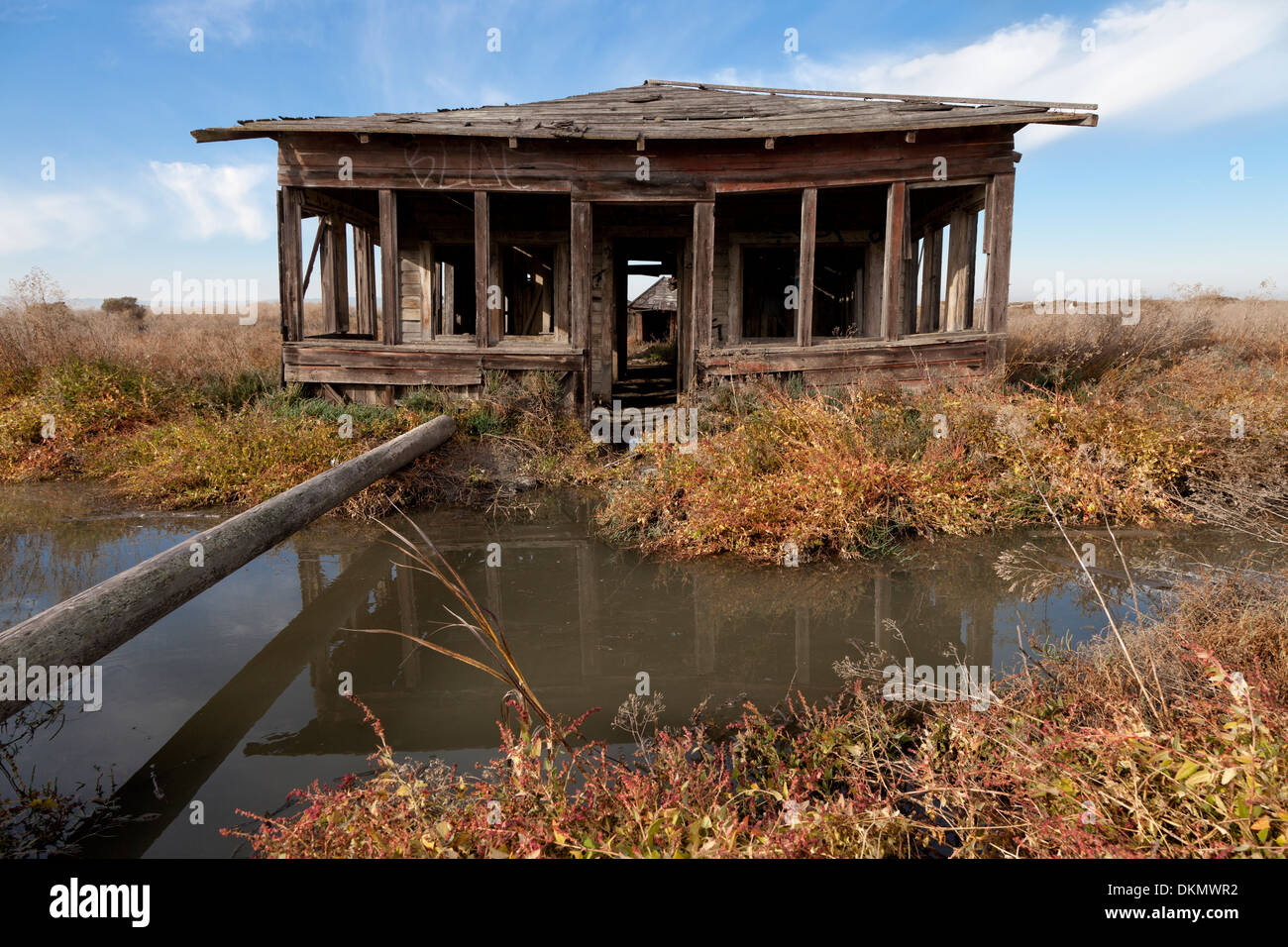 An abandoned shack slowly sinks into the marsh at the ghost town of ...