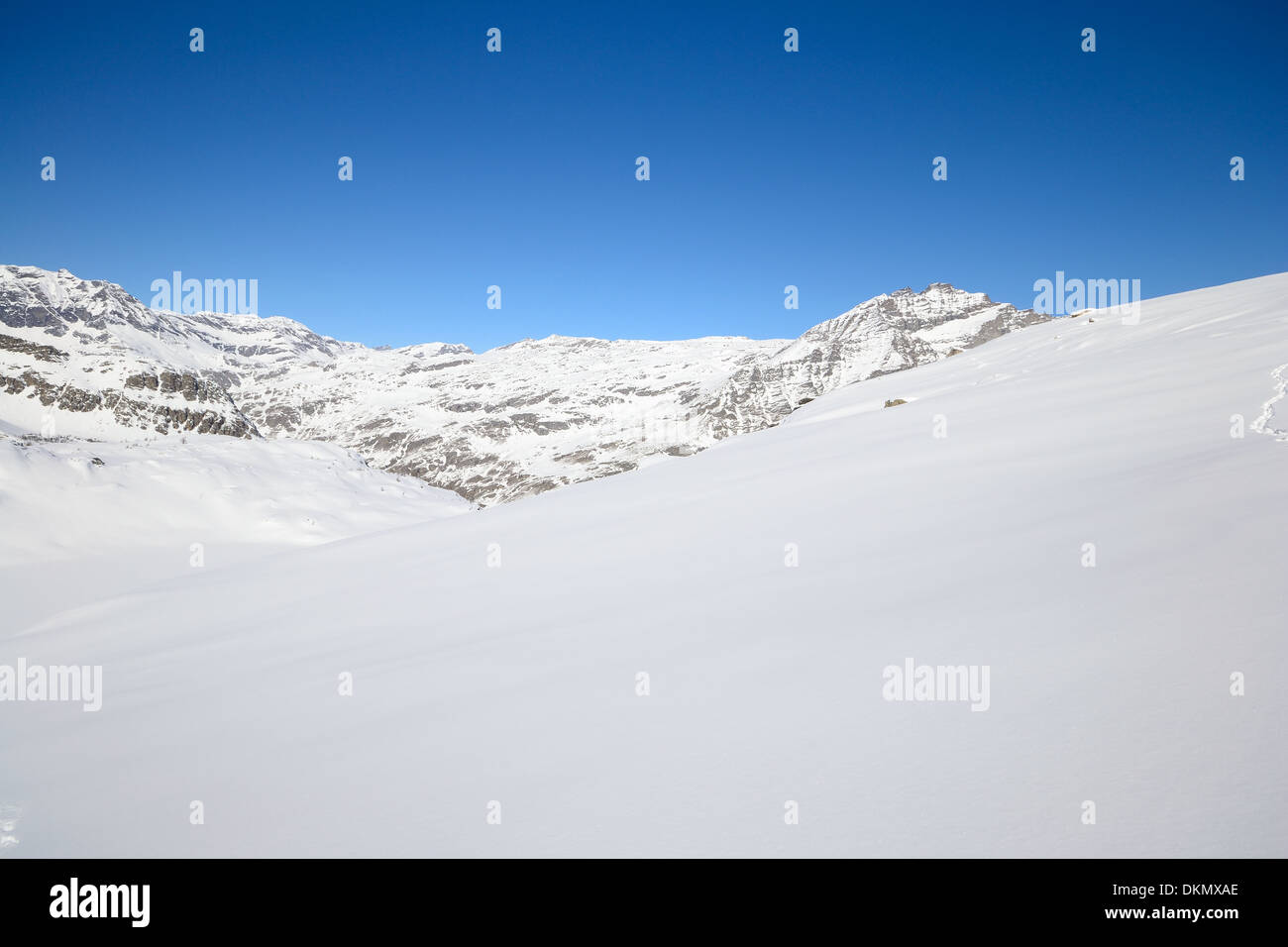 Off piste snowy slope in majestic high mountain frozen scenery and ...