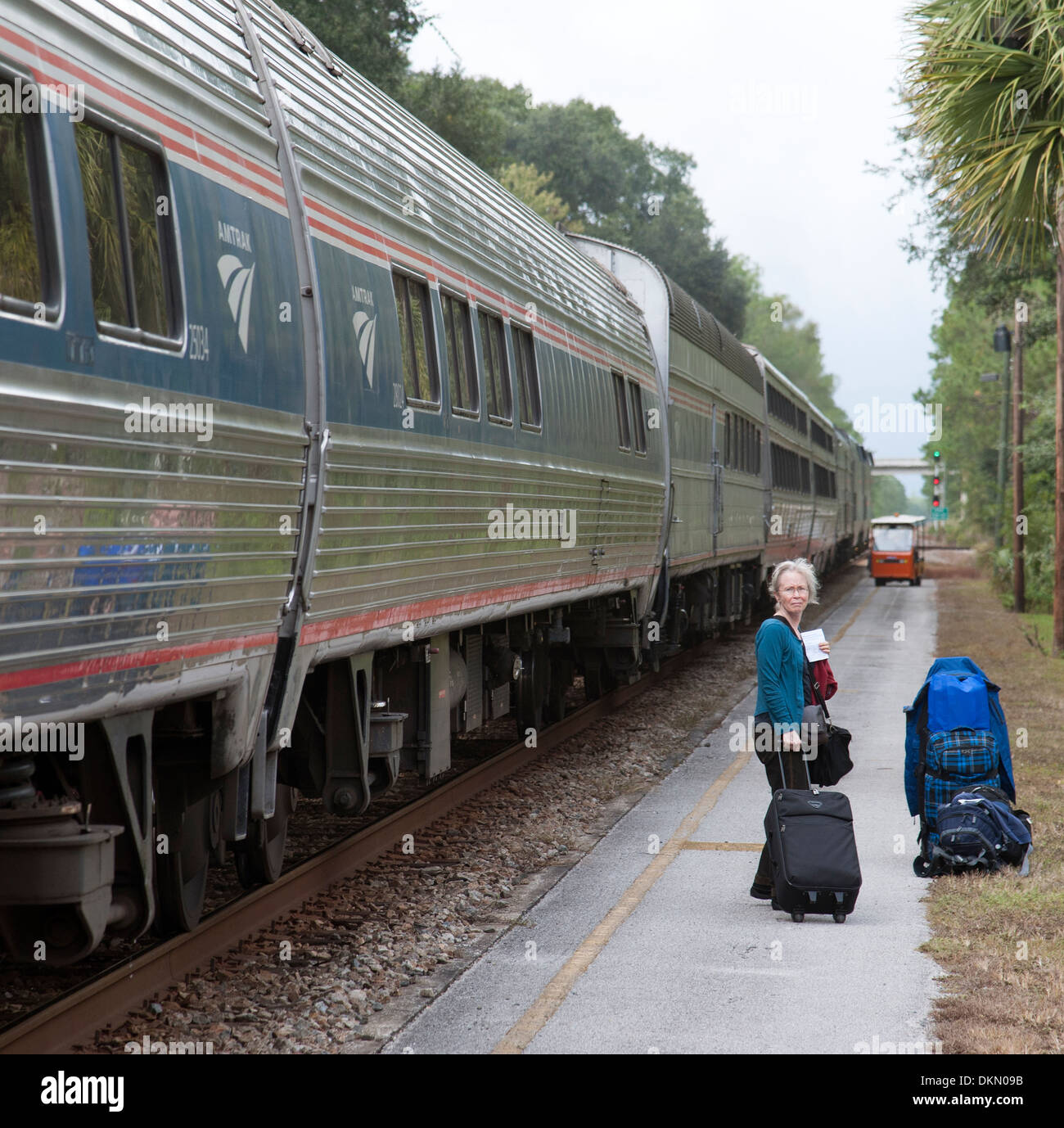 Railroad train passengers board and alight at DeLand Station Florida ...