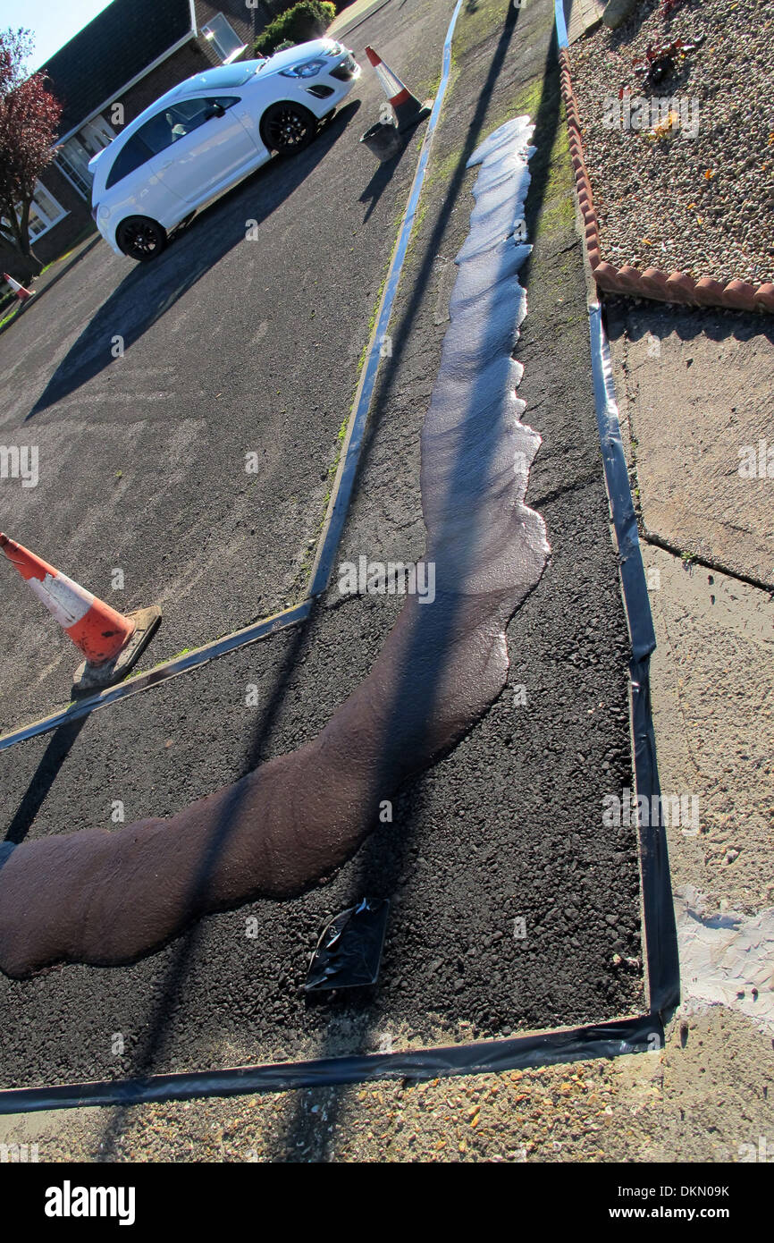 Slurry seal process, operators levelling, material layer, footway, create new surface, walk on ...