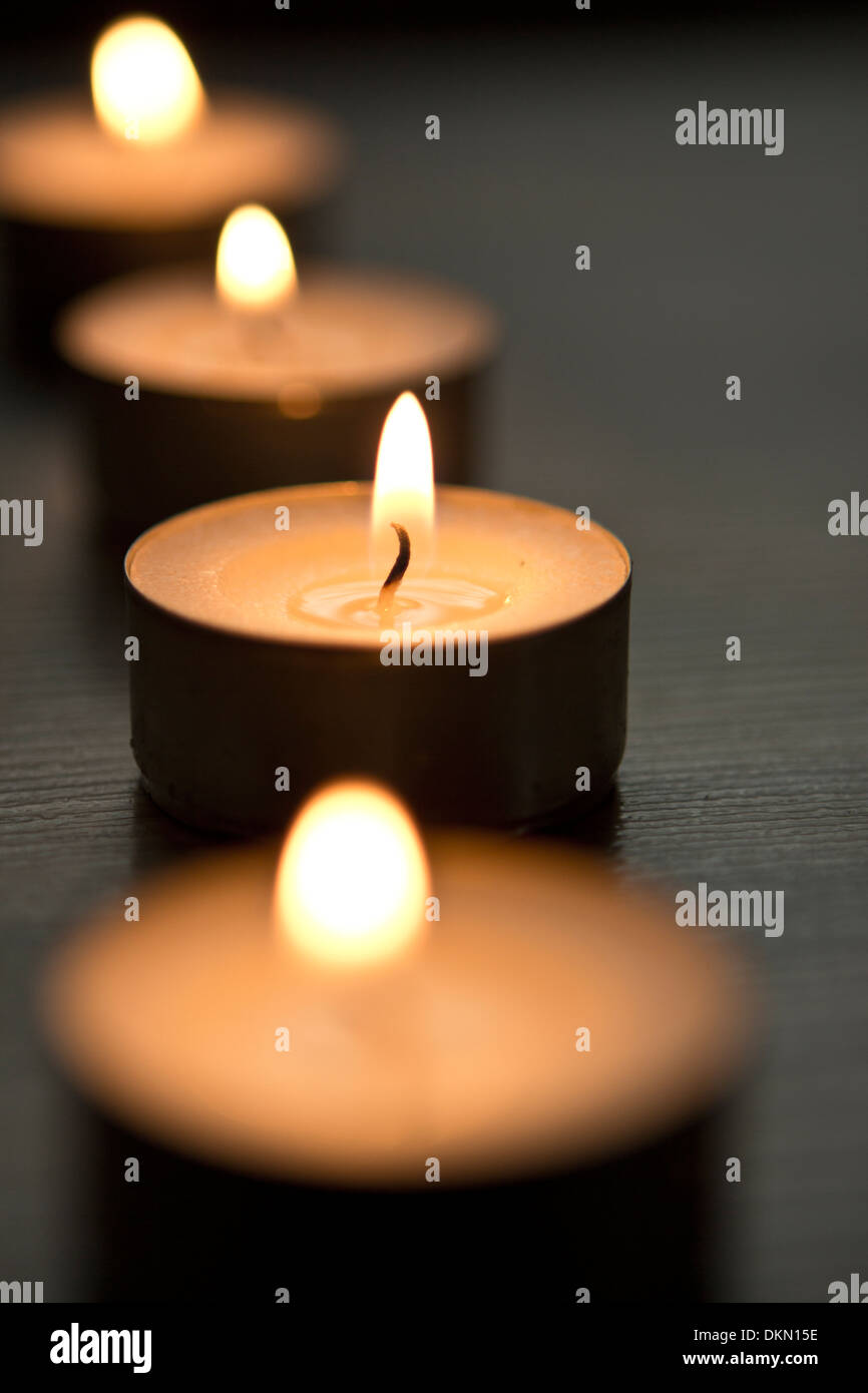several tealights with wooden background Stock Photo - Alamy