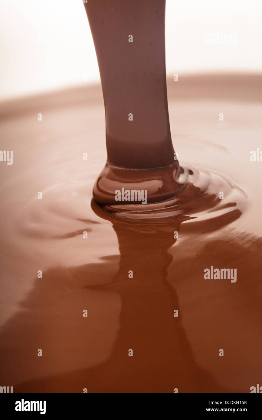 Chocolate flow close up as a background Stock Photo - Alamy