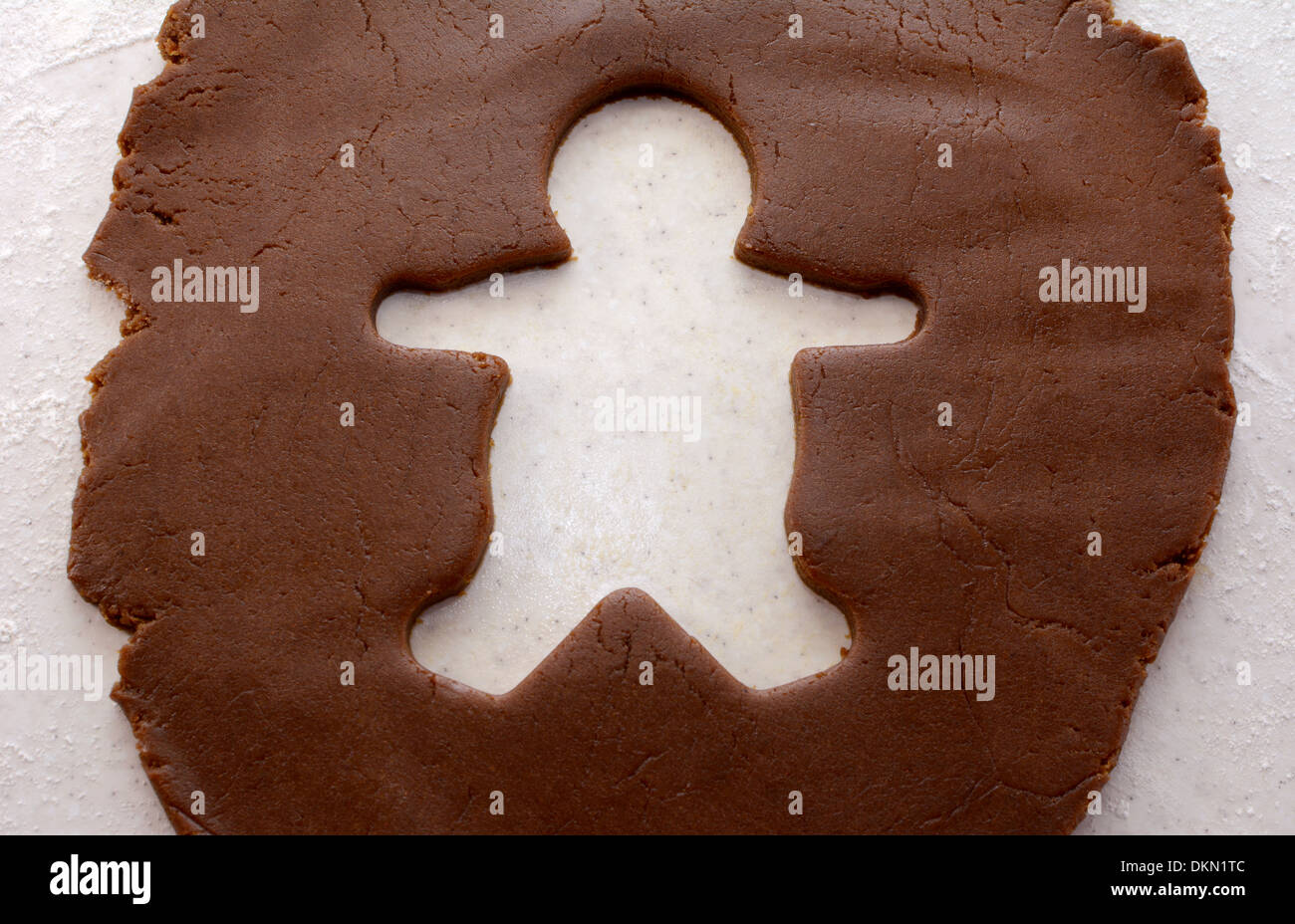 Empty cutout shape of a gingerbread man in biscuit dough Stock Photo ...