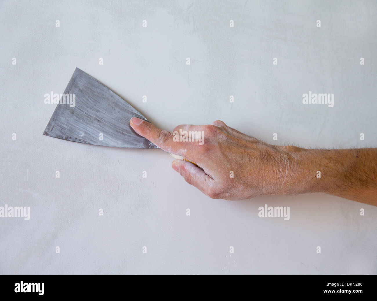 Plastering man hand with plaste and plaster spatula trowel in wall ...