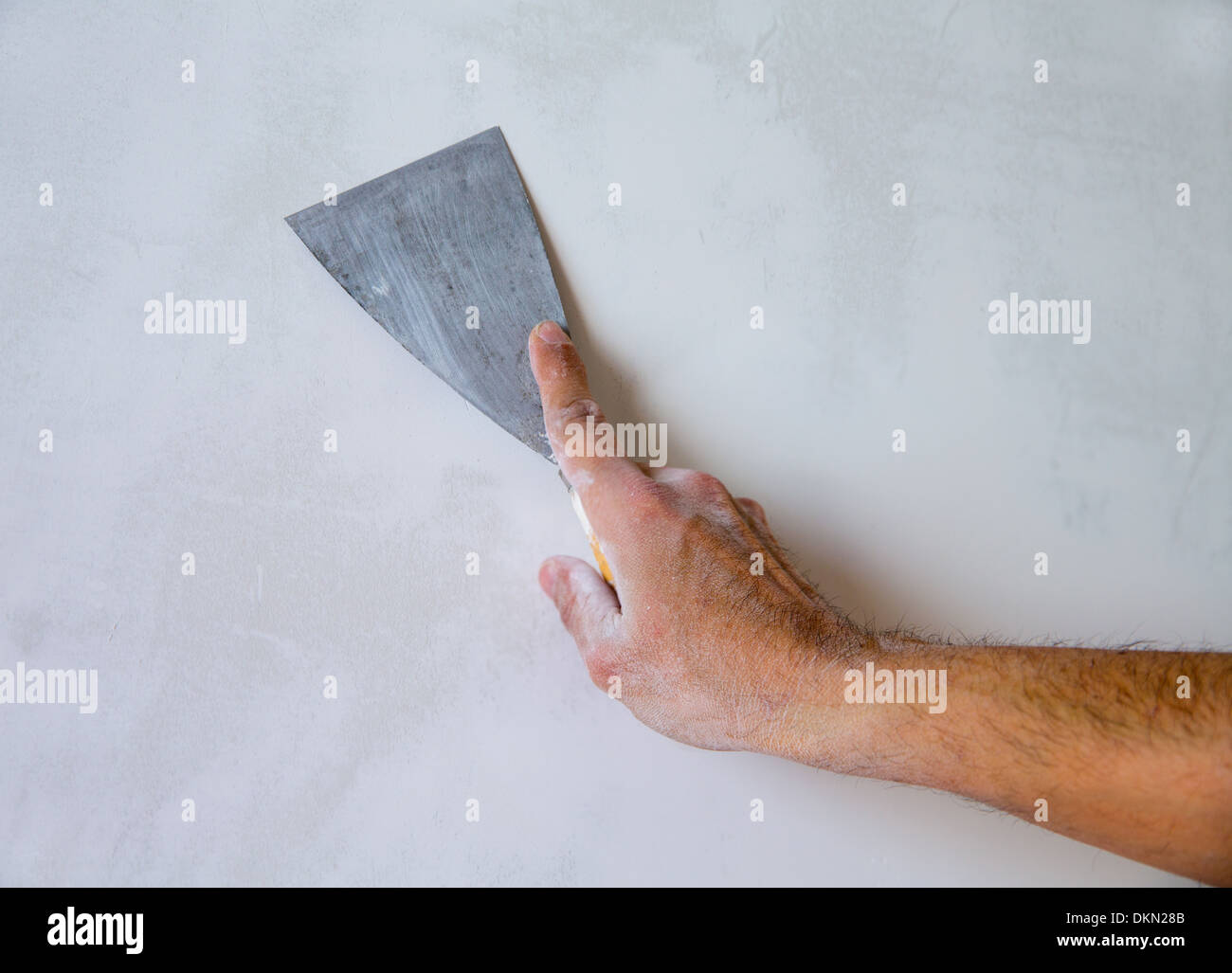 Plastering man hand with plaste and plaster spatula trowel in wall ...