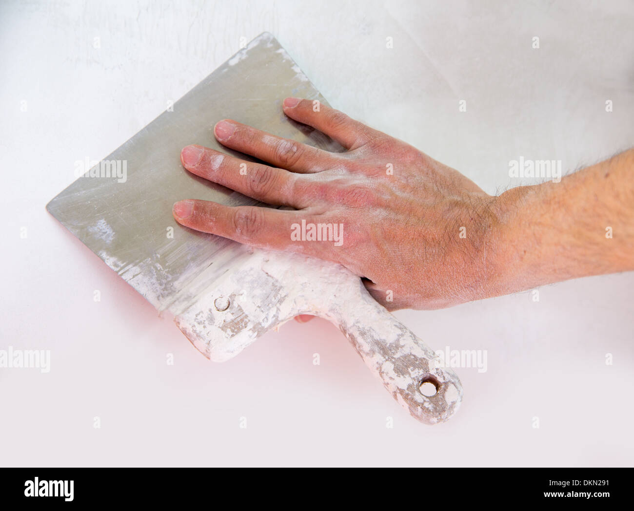 Plastering man hand with plaste and plaster spatula trowel in wall ...