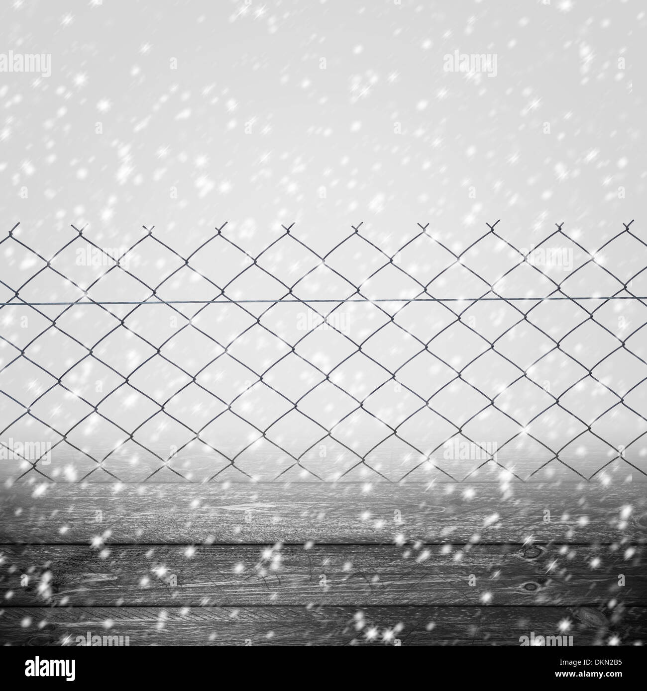Winter background with a wire fence. Falling snow Stock Photo - Alamy