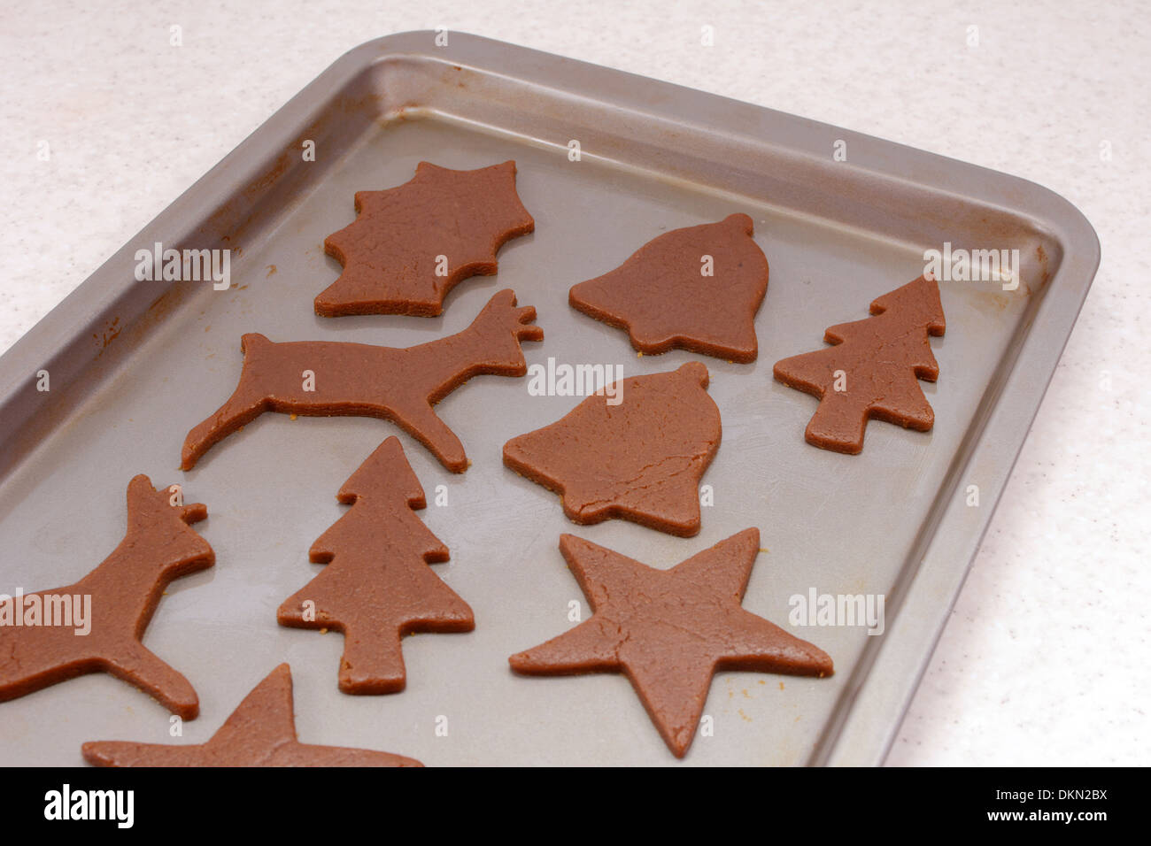Cookie sheet with uncooked gingerbread biscuits in festive shapes Stock ...