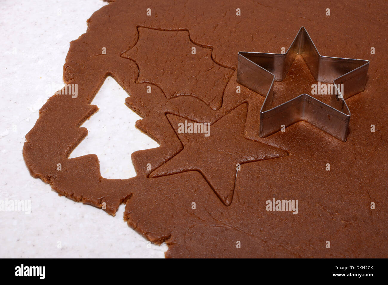 Festive shapes and star cookie cutter on gingerbread cookie dough Stock ...
