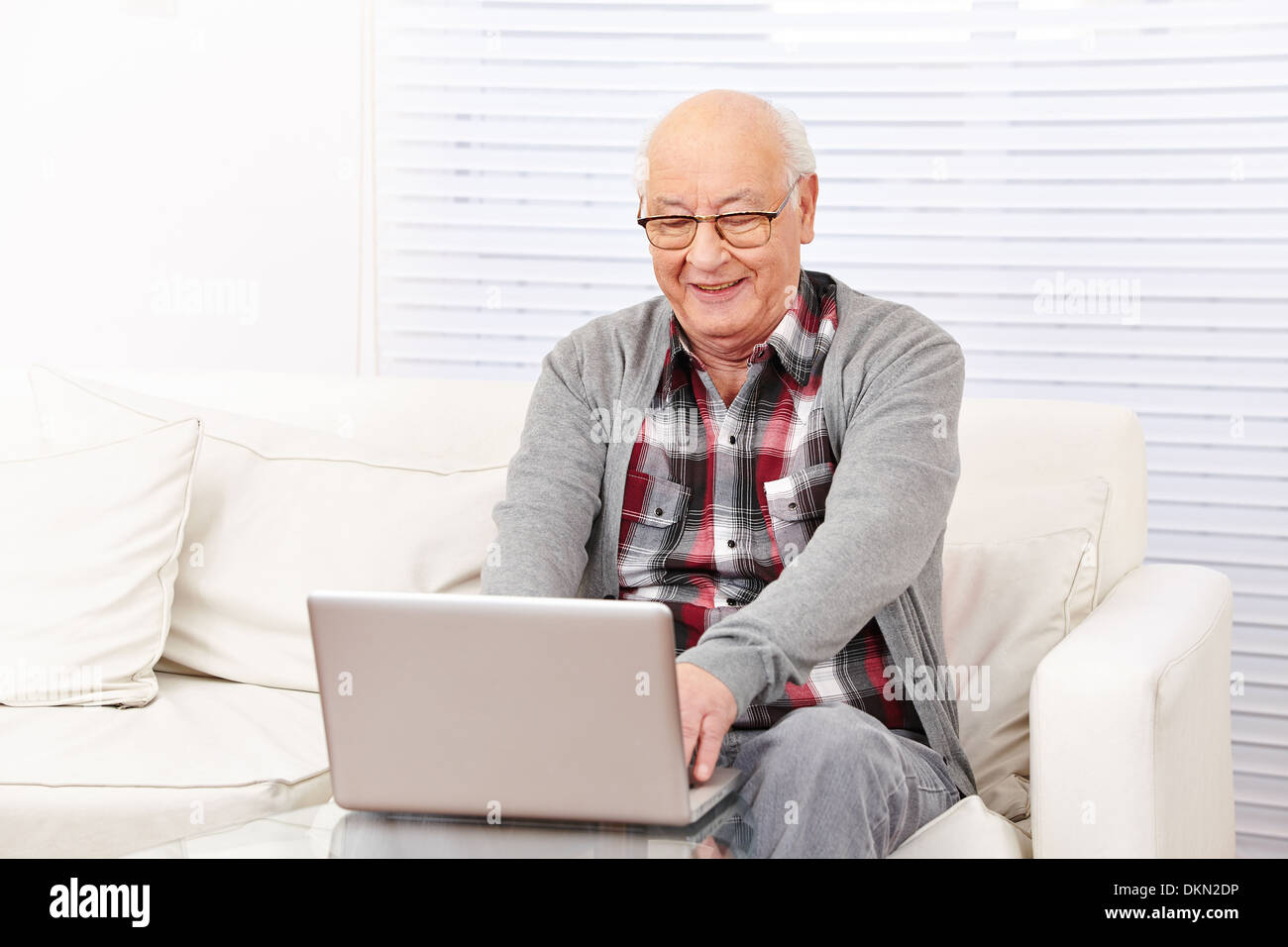 Happy senior citizen man working with computer in the internet Stock ...