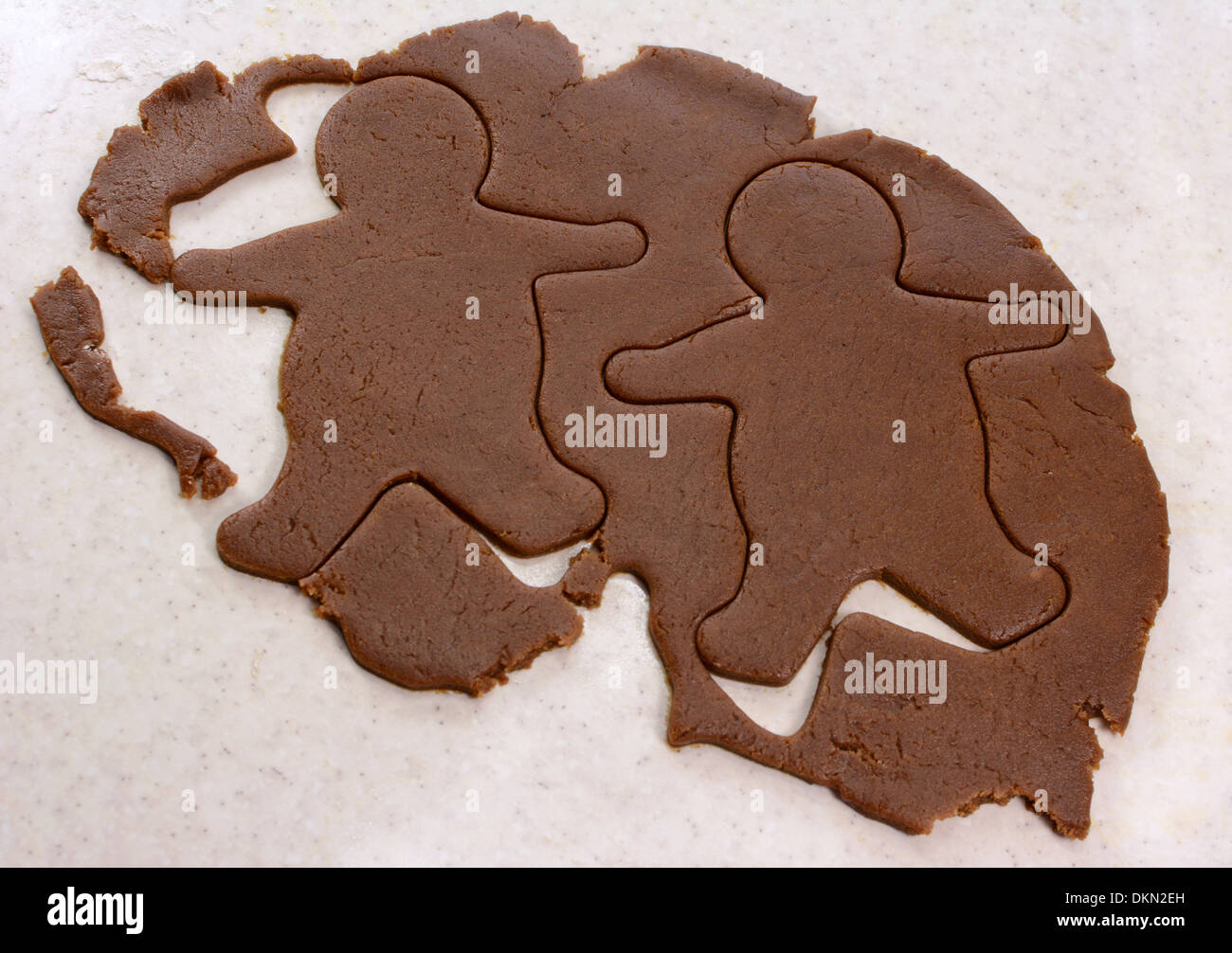 Two gingerbread men shapes cut into cookie dough Stock Photo - Alamy