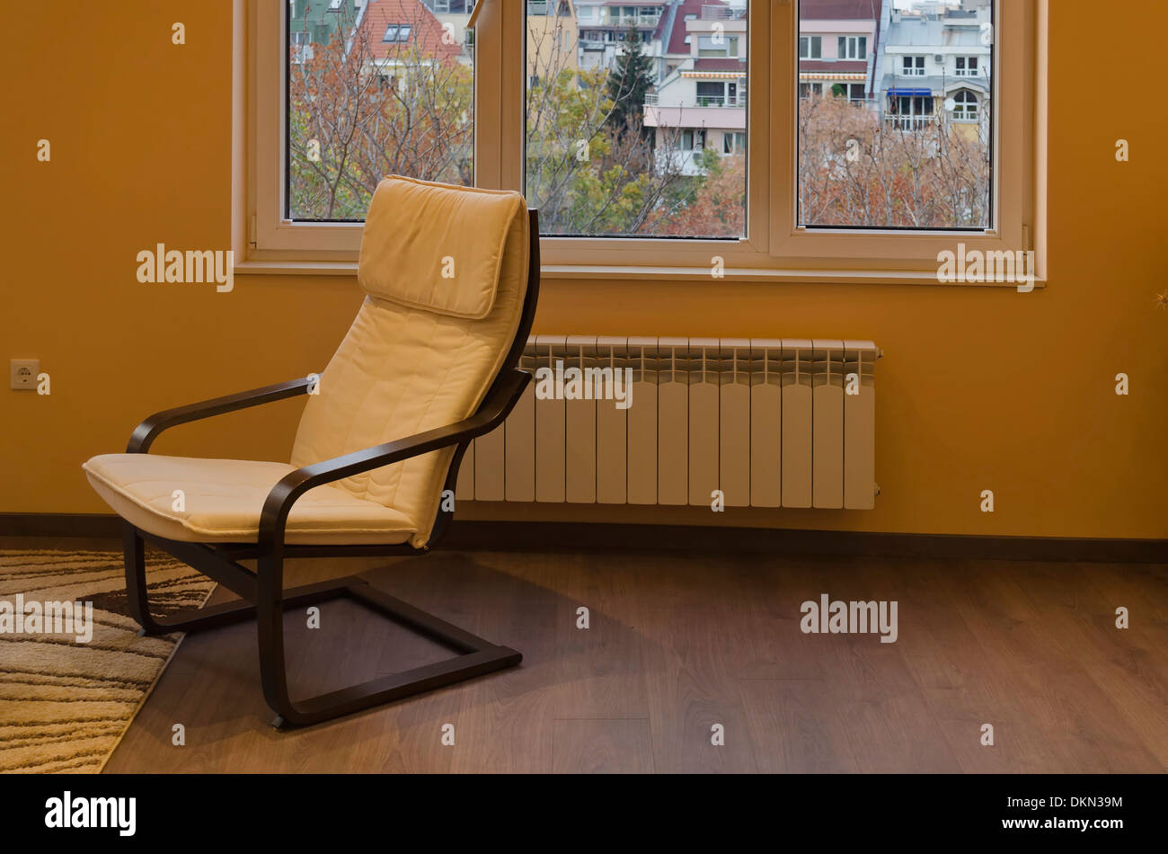 Beautiful corner in small living room with chair Stock Photo - Alamy