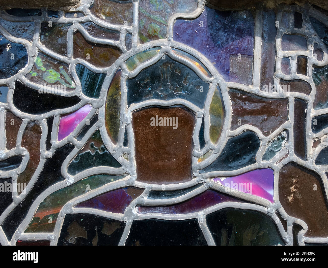 Exterior view of sunlit colourful stained leaded glass church window ...