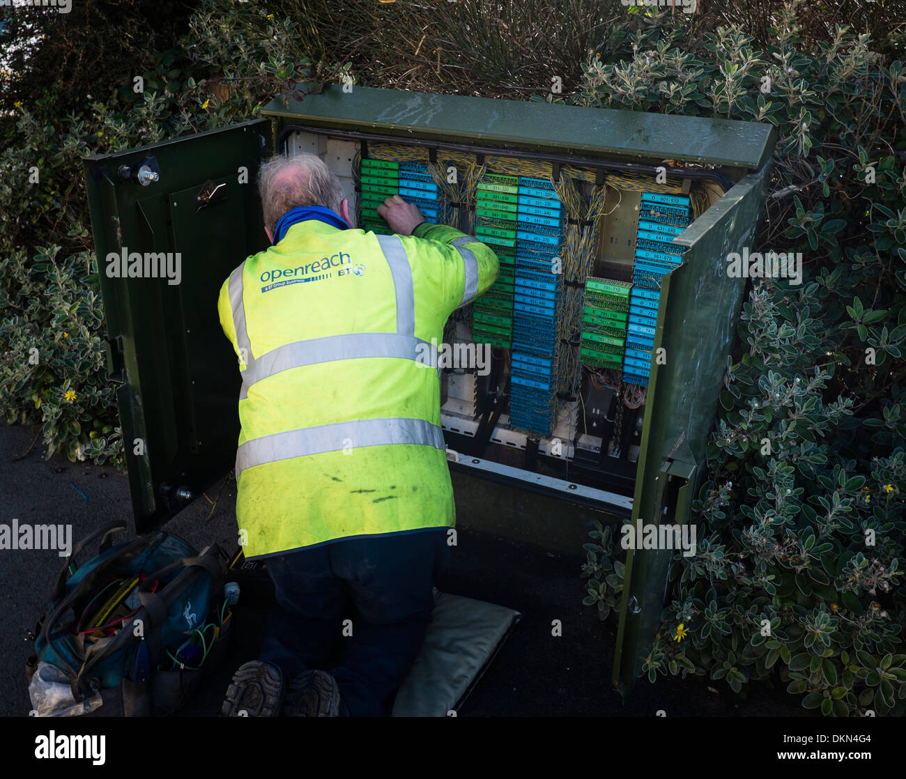 A BT OpenReach telecommunication engineer at work checking broadband ...