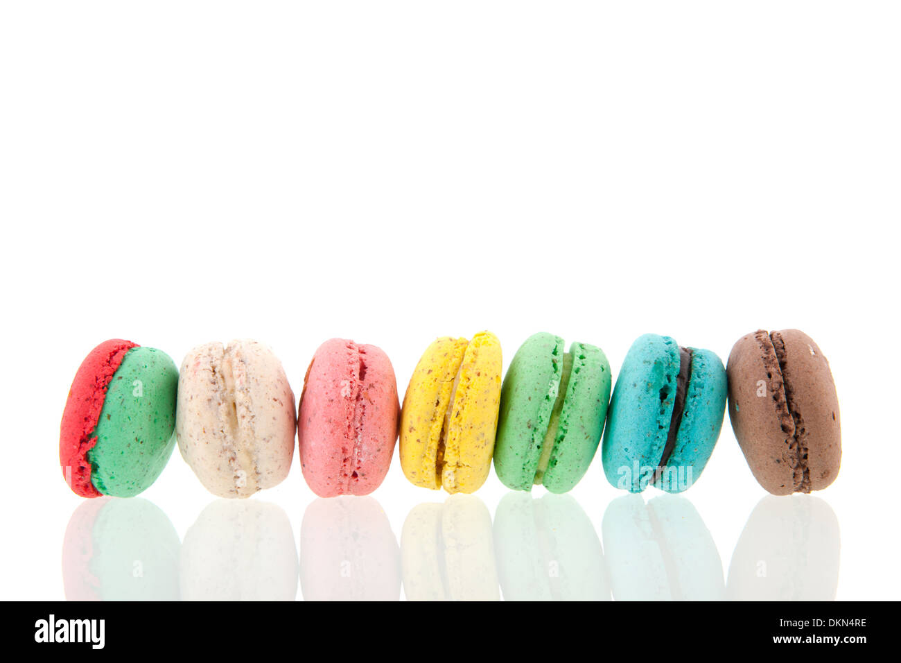 Row colorful macaroons isolated over white background Stock Photo - Alamy