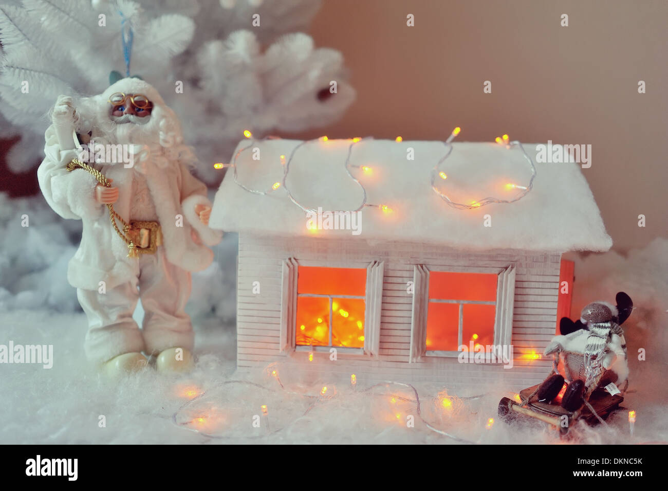 Snow White fairy house with lights and Santa Claus Stock Photo - Alamy