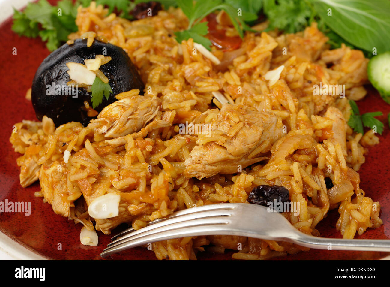 An authentic Saudi chicken kabsa (known in Qatar as majbous), garnished ...