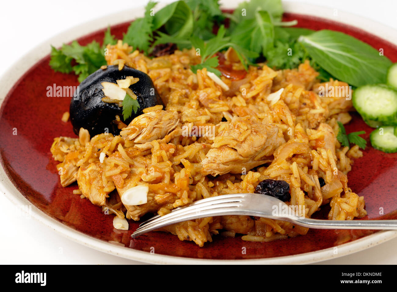 An authentic Saudi chicken kabsa (known in Qatar as majbous), garnished ...