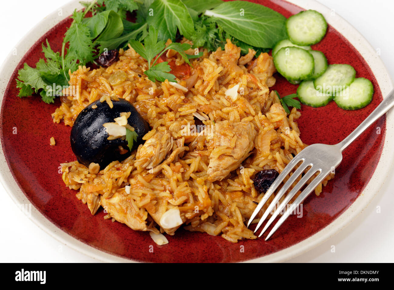 An authentic Saudi chicken kabsa (known in Qatar as majbous), garnished ...