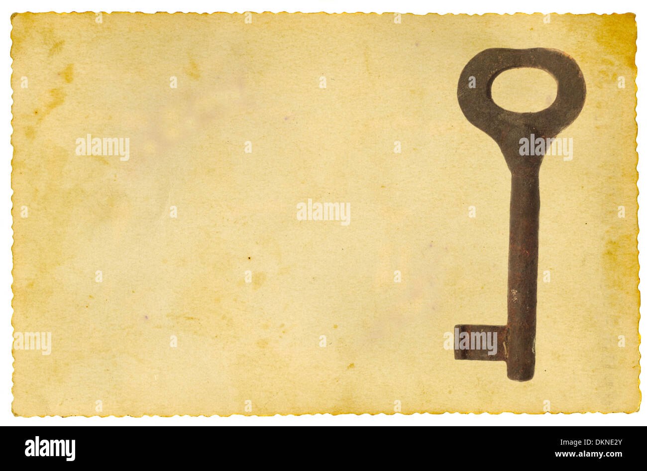 Old metal key on vintage paper background Stock Photo - Alamy
