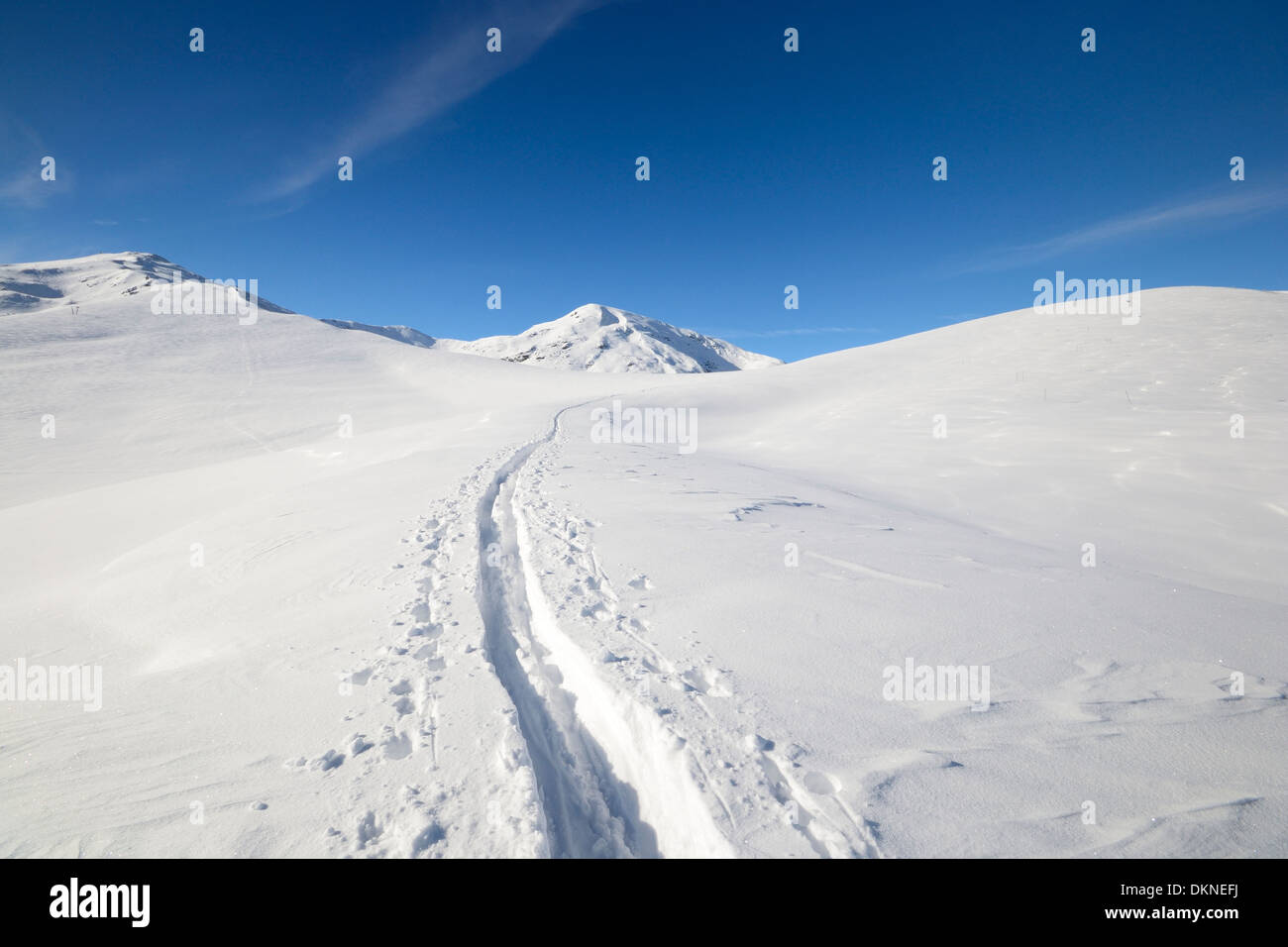 Back country ski tracks in scenic winter landscape with candid slope ...