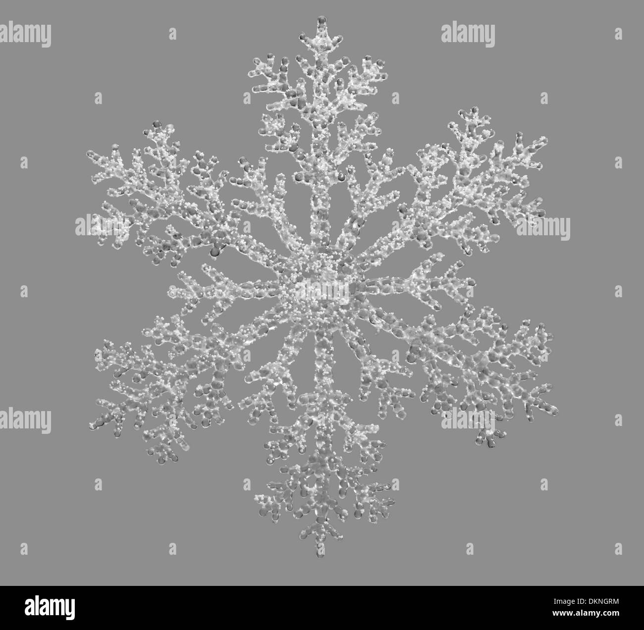 artificial clear snowflake isolated in grey back Stock Photo - Alamy