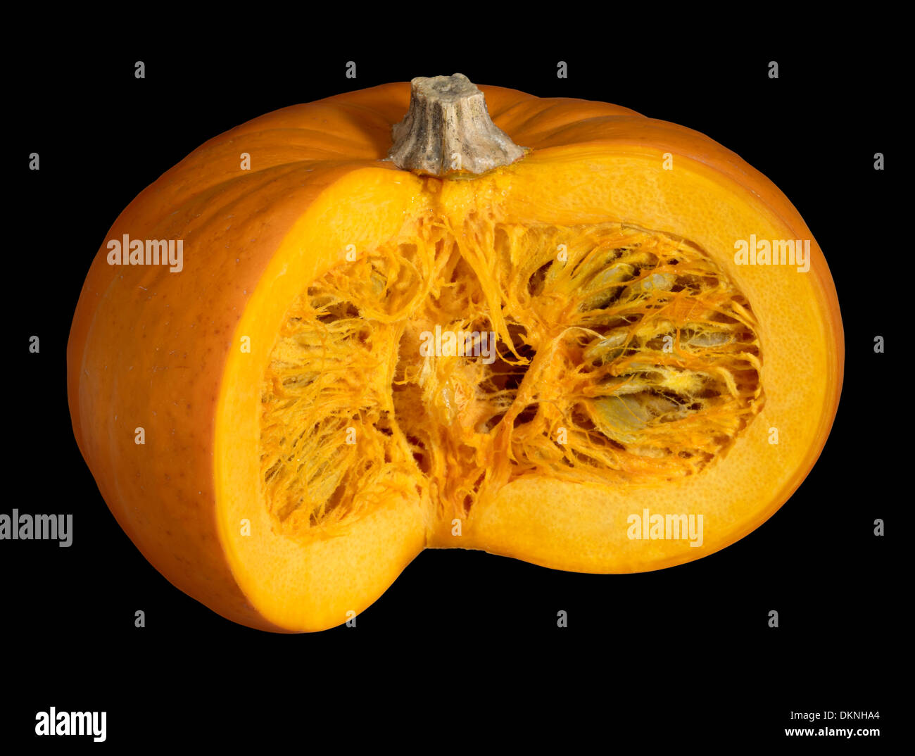 open orange punpkin in black back Stock Photo - Alamy