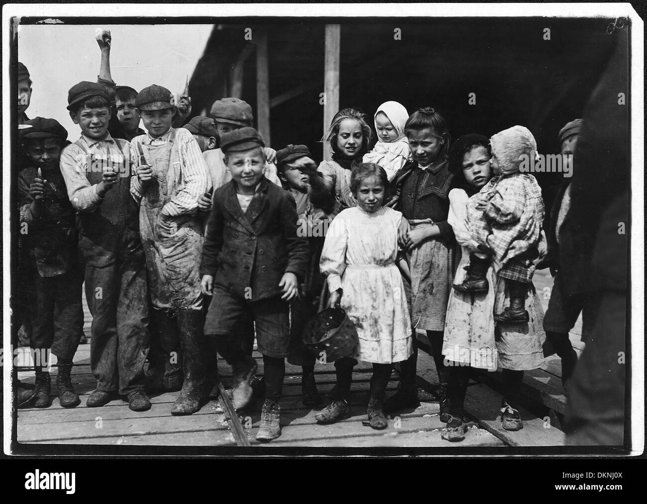 Children, excluding babies, are seen shucking oysters and caring for ...