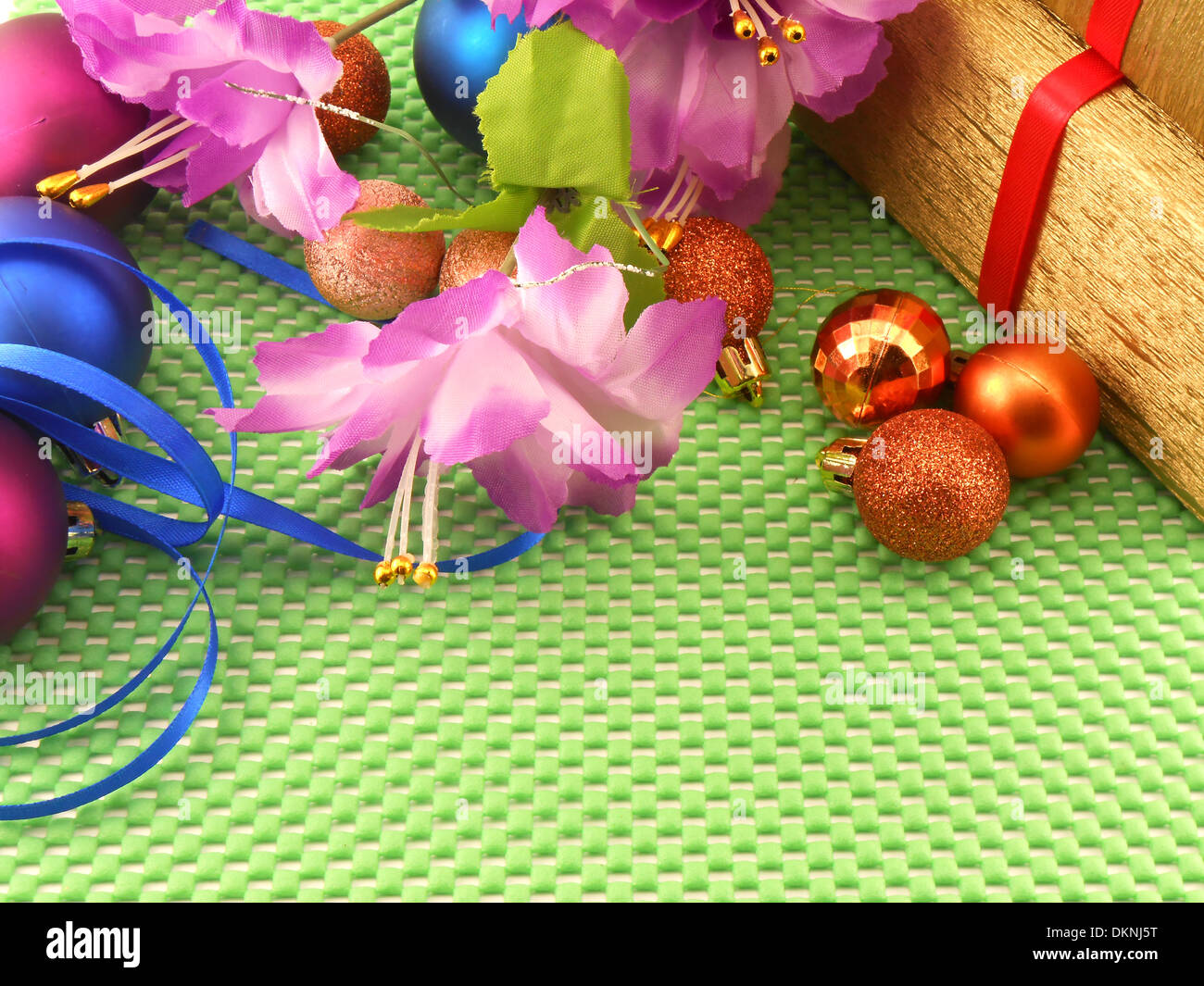 beautiful flowers, gifts and Christmas balls on green background Stock ...