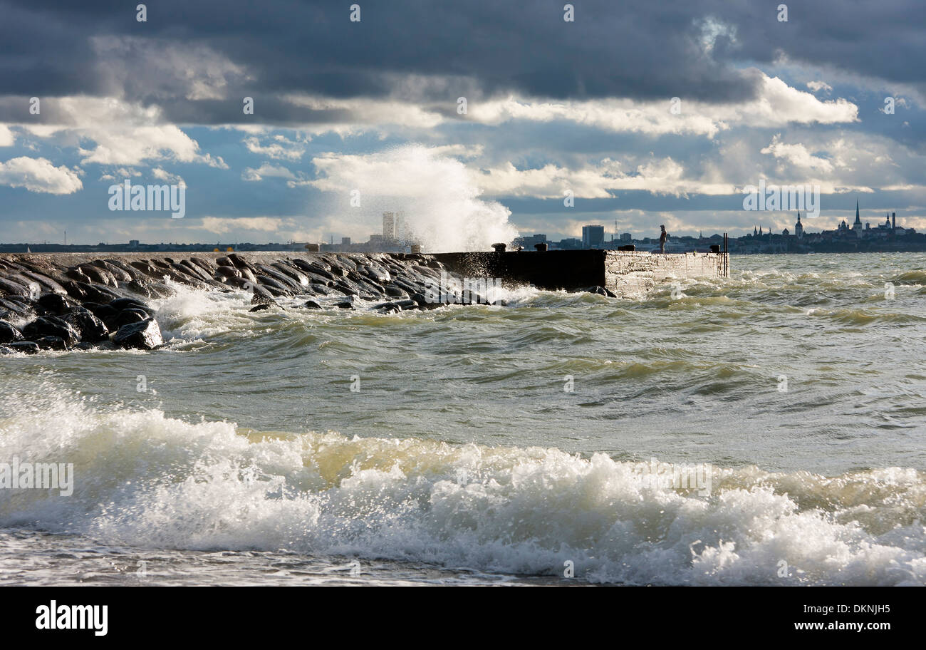 Pier or quay in a stormy and turbulent sea at a gloomy but but sunny ...