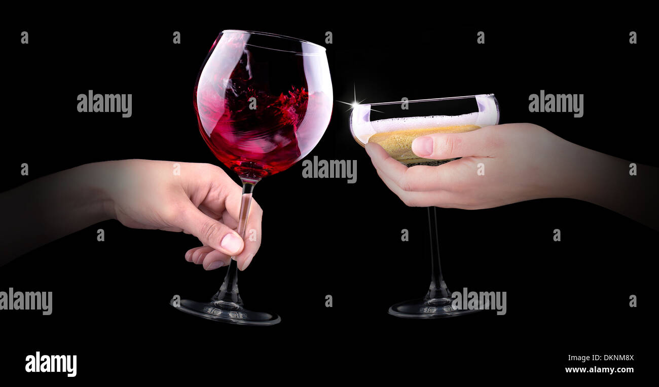 hand making toast with glass of red splashing wine and champagne on ...