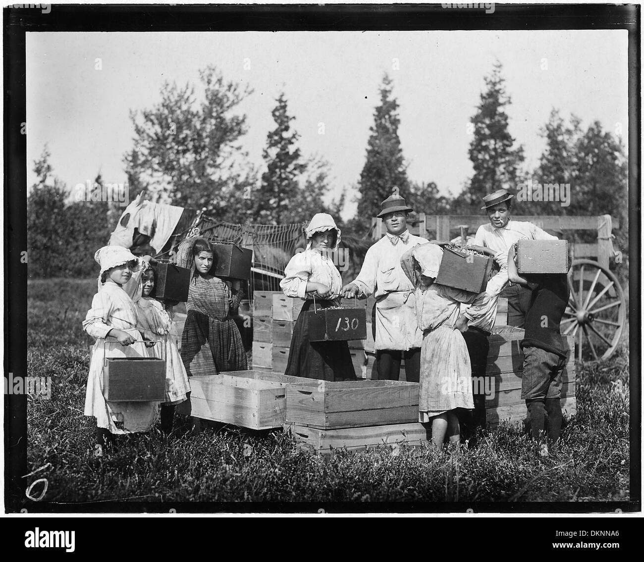 A group of children carrying pecks of goods to a bushel man, with the ...