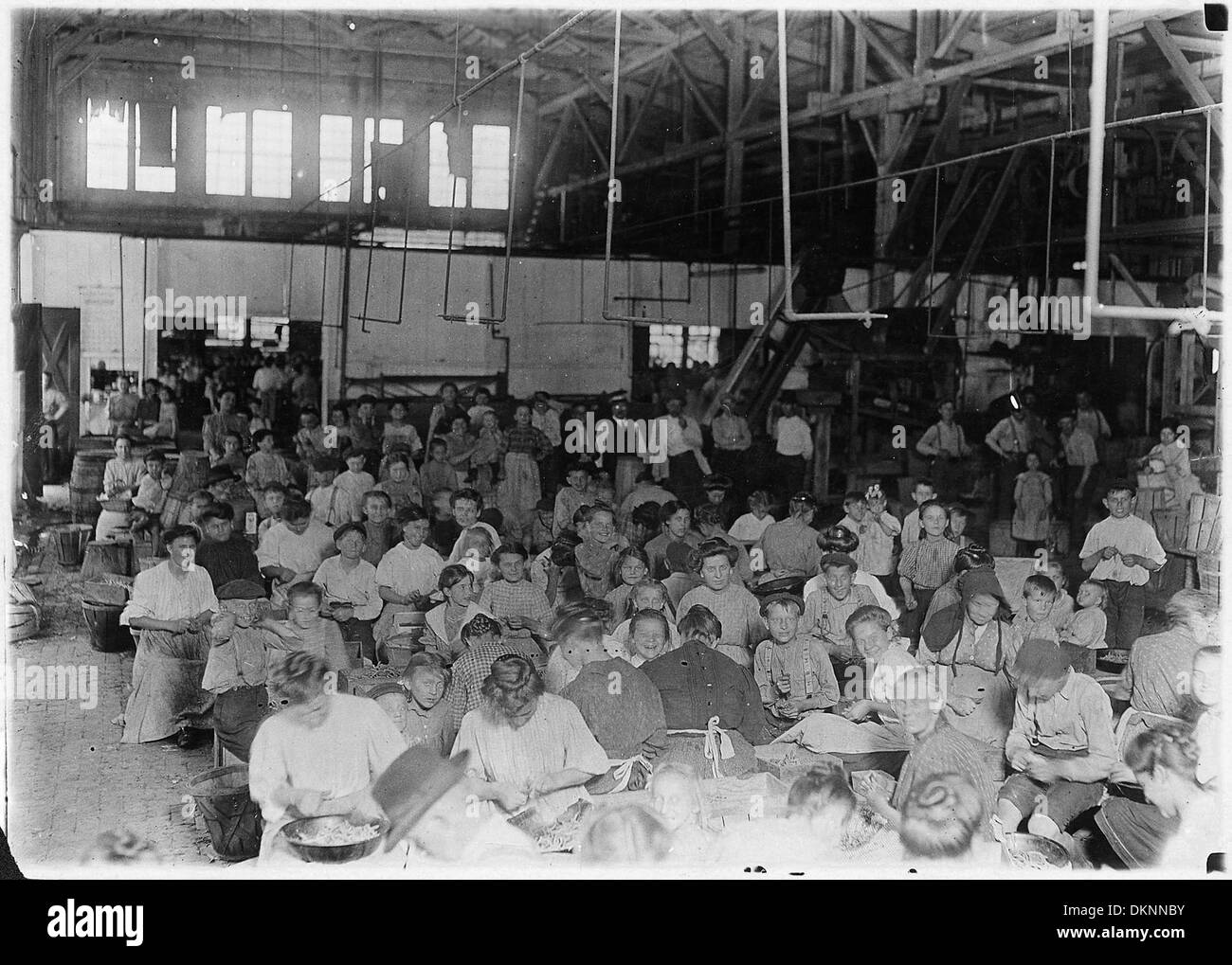 This image depicts workers stringing beans at the J.S. Farrand Packing ...