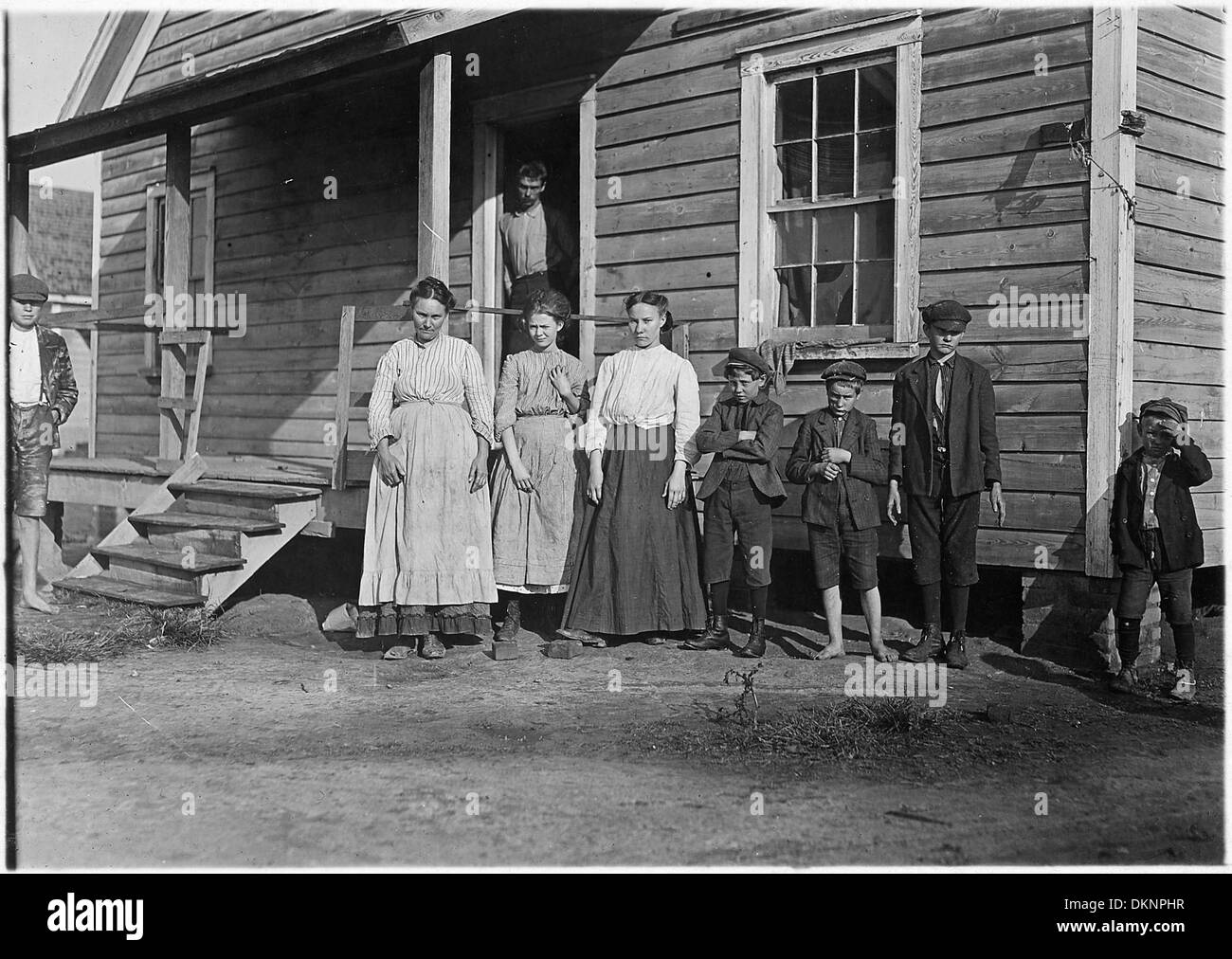 A family works together in a mill, with the father standing at the ...