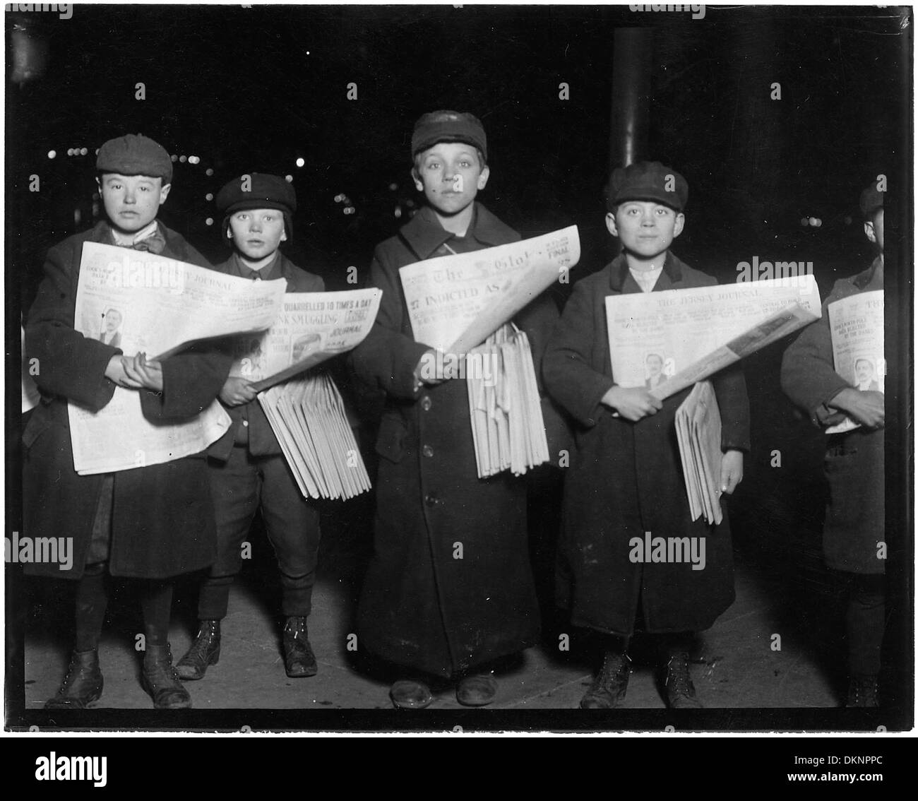 Newsie selling at the Hudson Tunnell Station, Jersey City. Boy on left ...