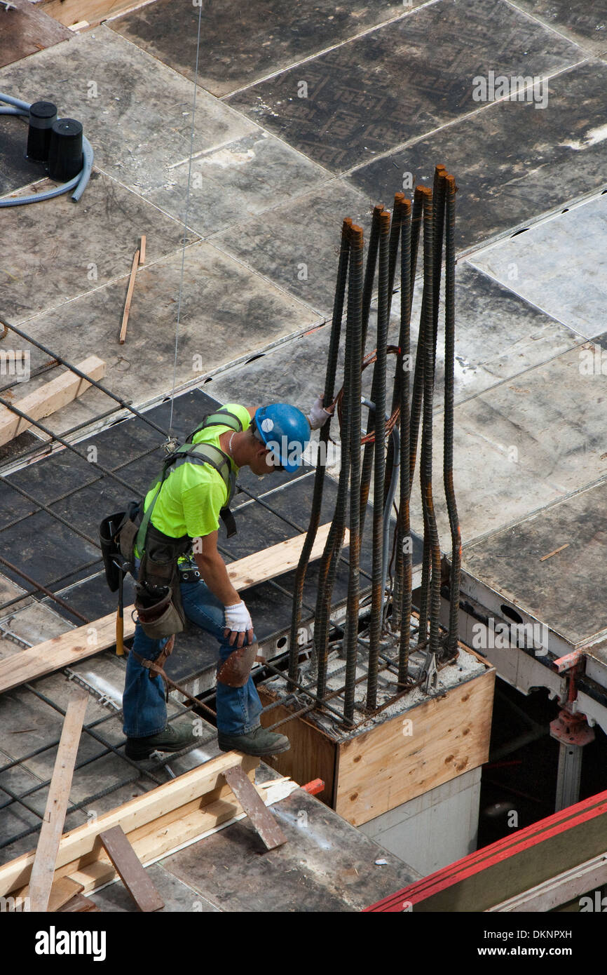 A construction worker on site checking on building progress Stock Photo ...