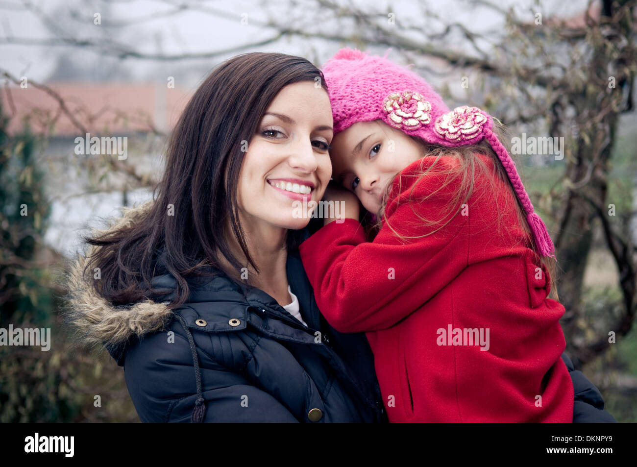 Mother holding daughter in cap hi-res stock photography and images - Alamy