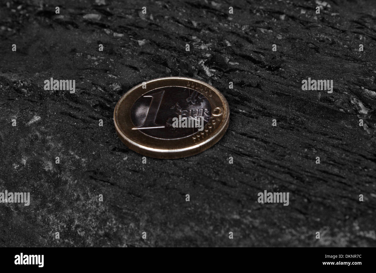 Coal and euro coin Stock Photo - Alamy