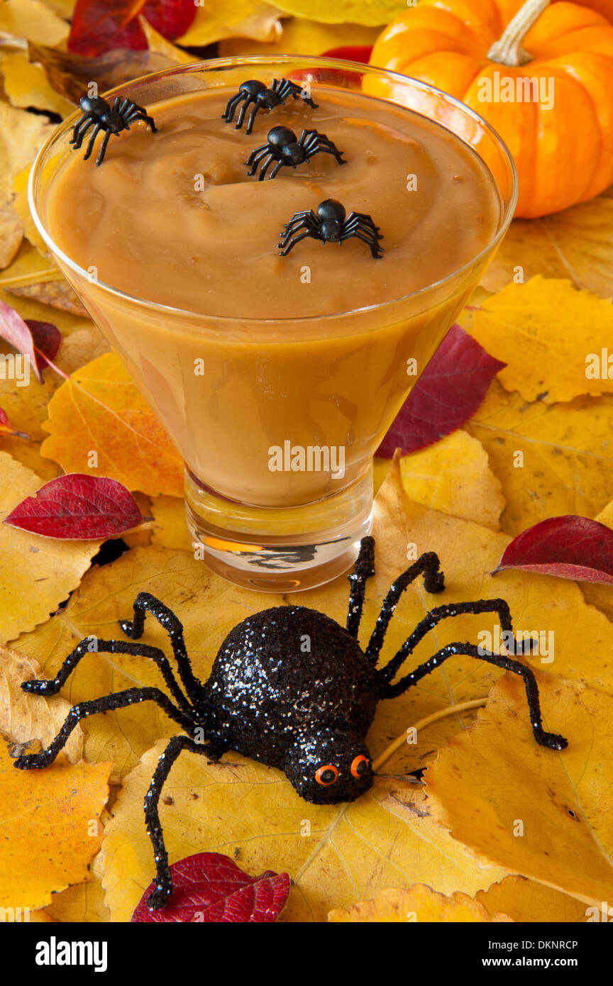 Spiders decorate a dish of butterscotch pudding for Halloween Stock ...