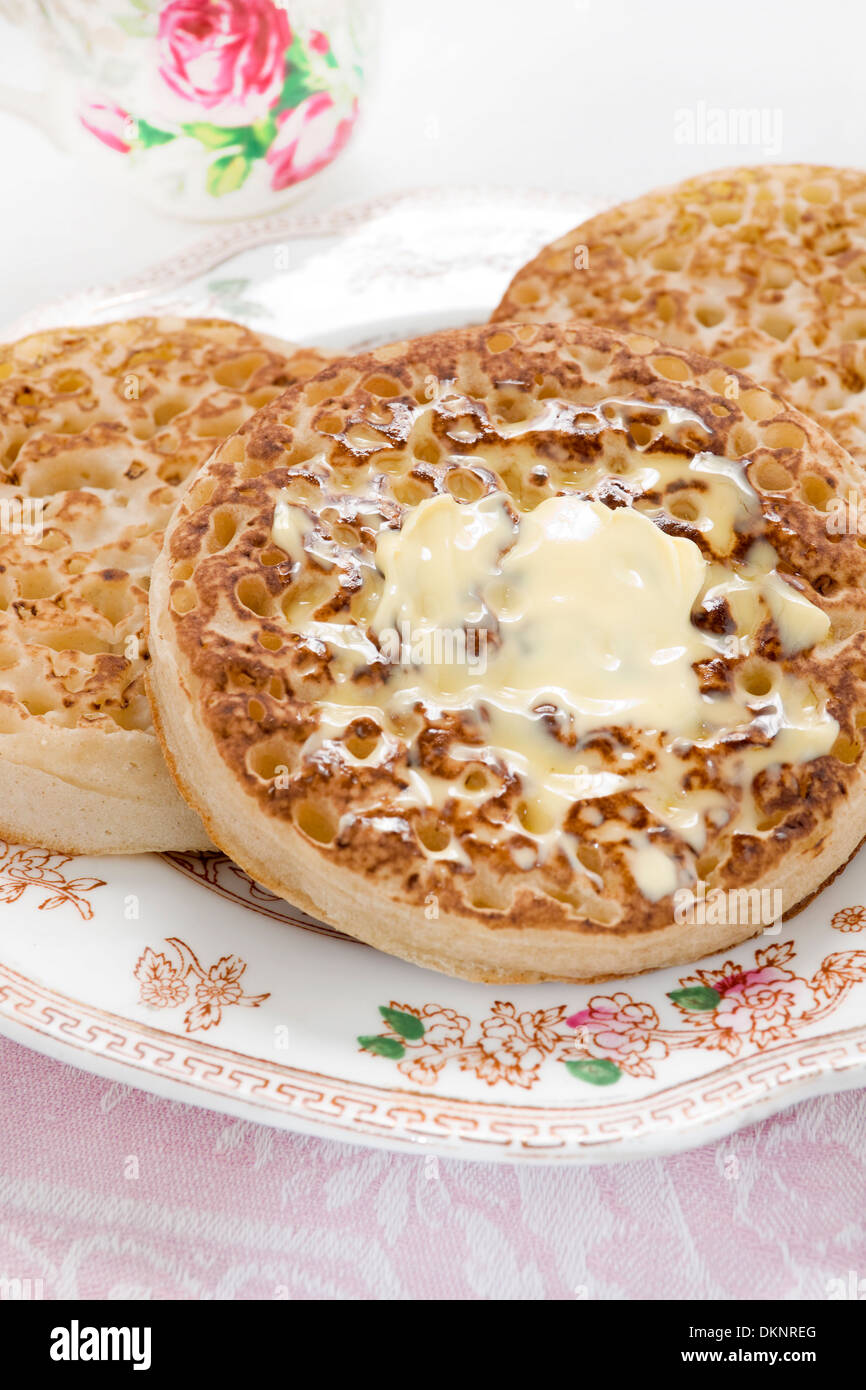 Toasted crumpets with melting butter Stock Photo - Alamy