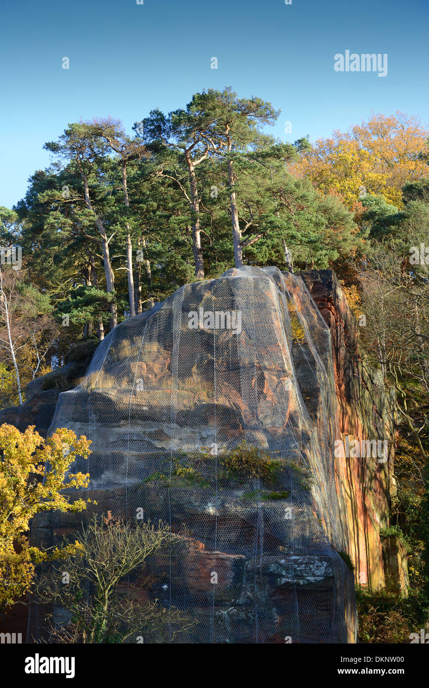 Sandstone cliff face retained by wire netting to prevent rock fall in ...