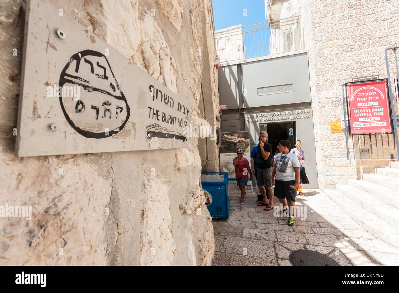 Jerusalem, Israel. People passing by the sign of the "Burnt House ...