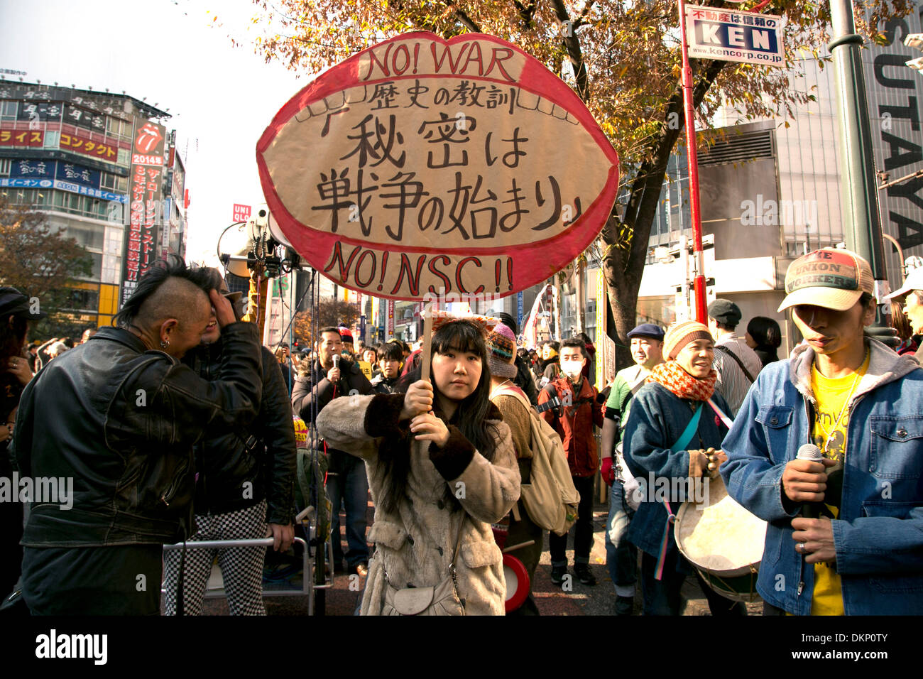 Tokyo, Japan. 7th Dec, 2013. Protestor holds a placard during the rally ...