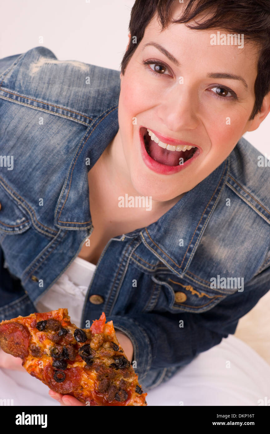 A very excited female enjoys a supreme meat crispy pizza Stock Photo ...