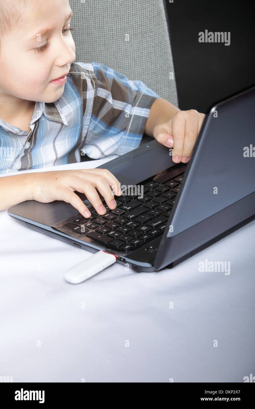 Computer addiction child boy with laptop notebook black background ...