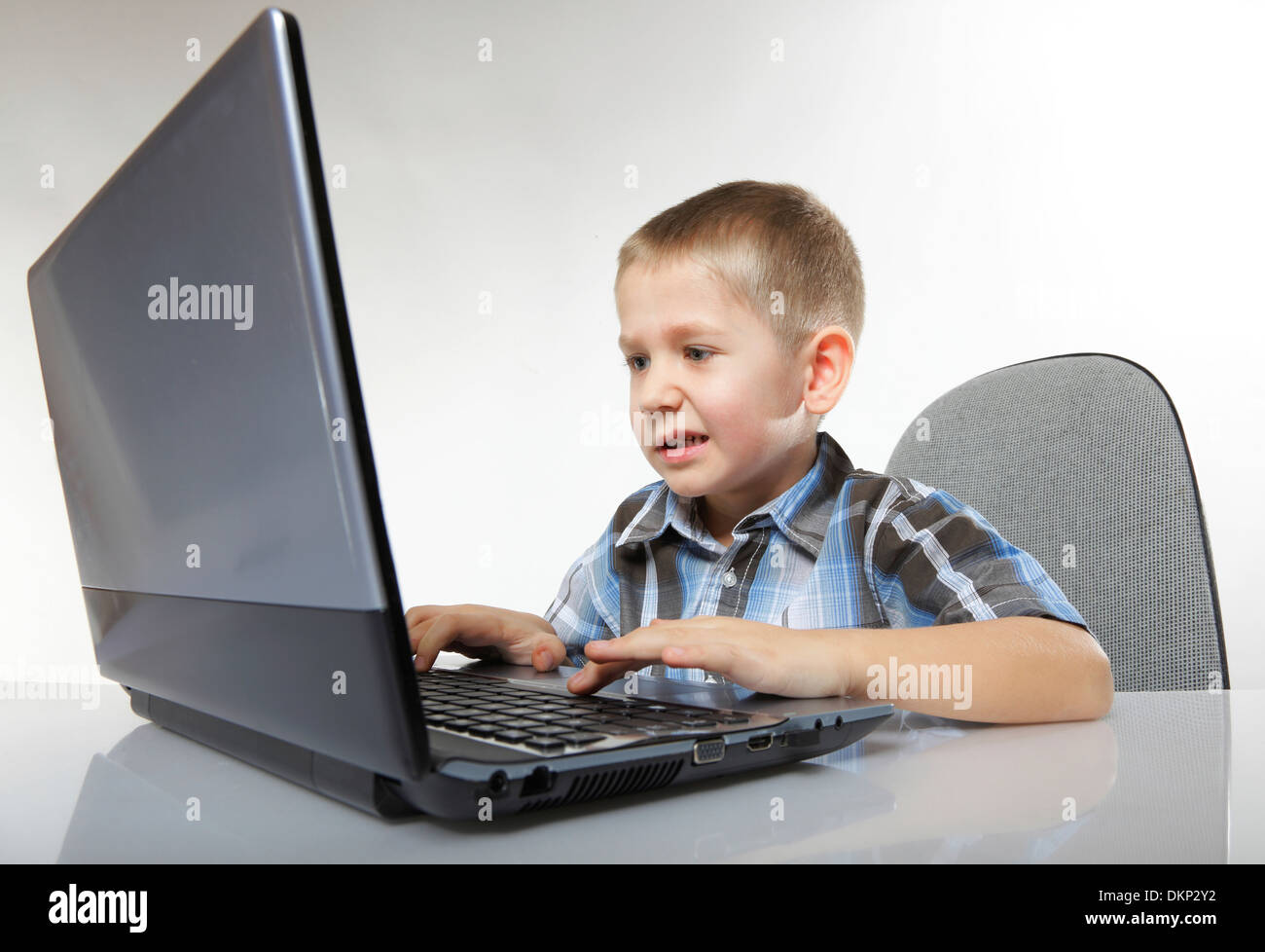 Computer addiction emotional child boy with laptop notebook playing ...