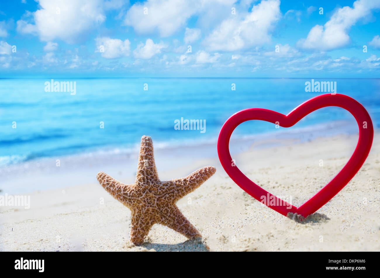 Heart shape and starfish on sandy beach by the ocean in sunny day Stock ...